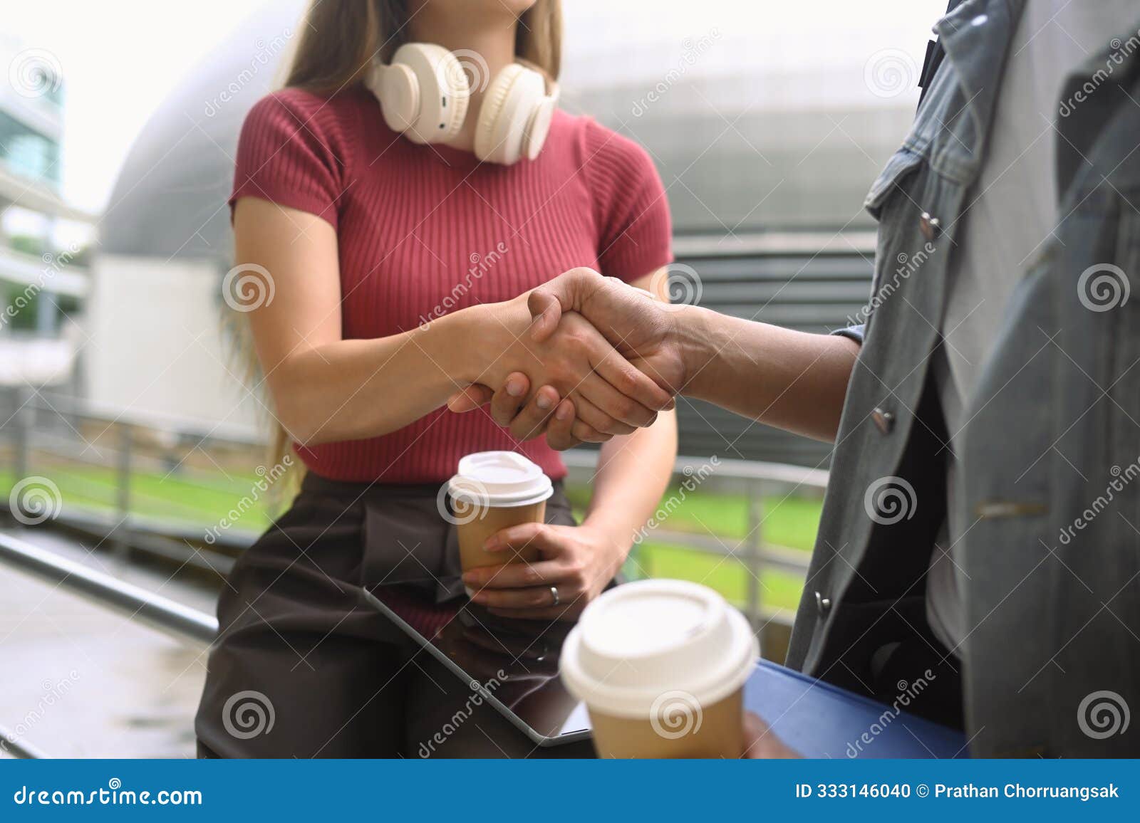 Two Students Shaking Hands Outdoors, Symbolizing a Friendly Agreement ...
