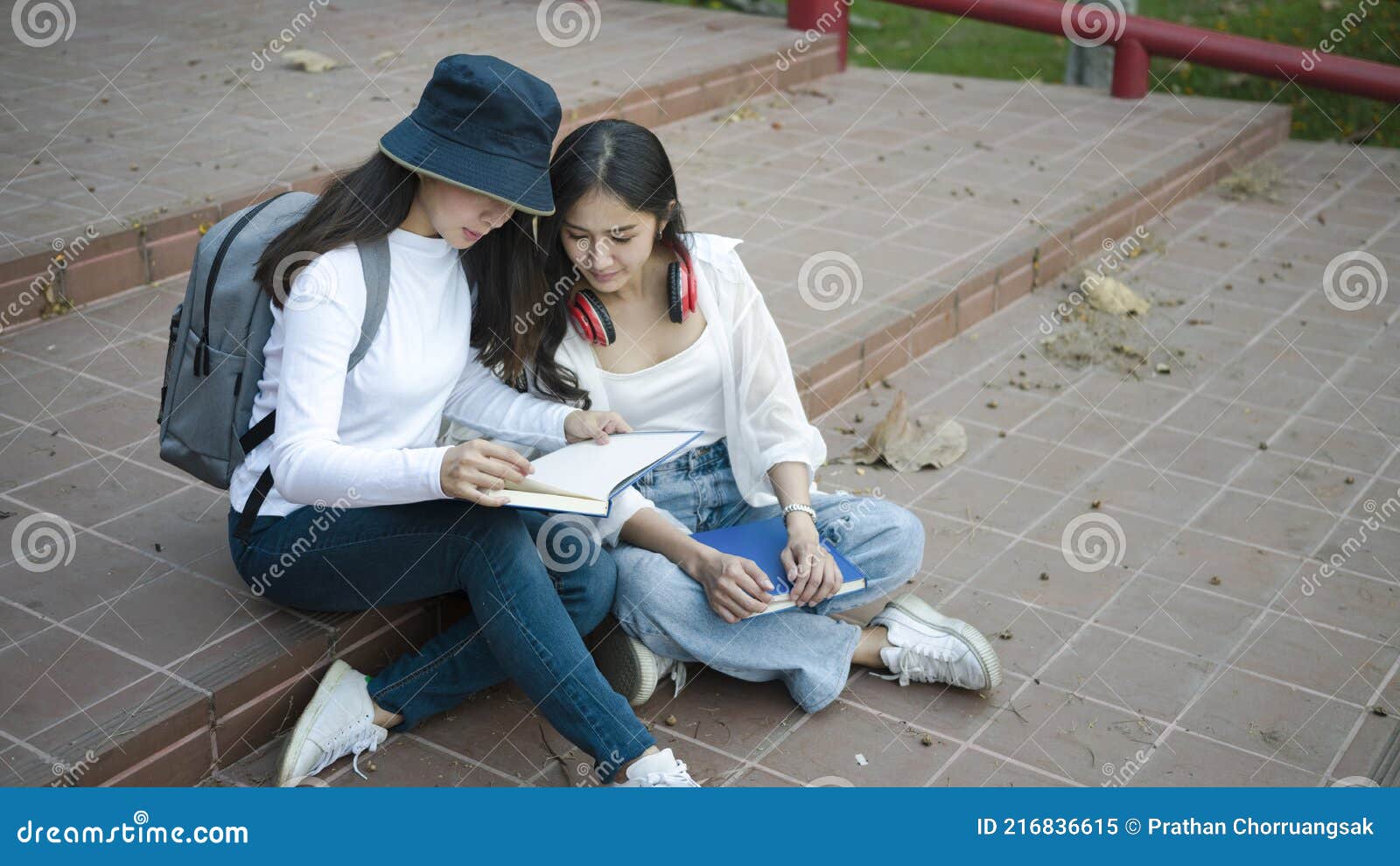 Two Students Sharing Notes while Sitting on Staircase in the University ...