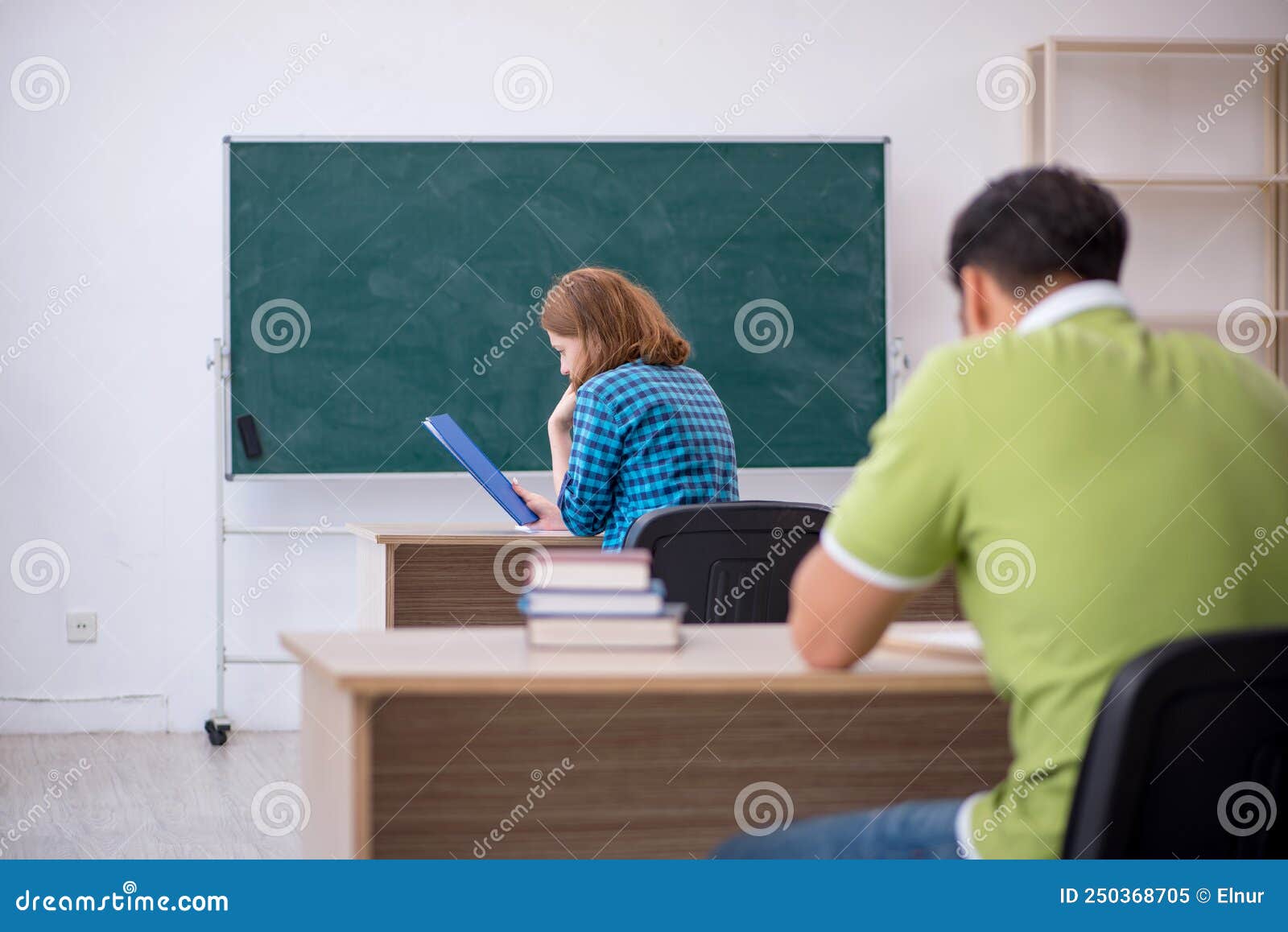Two Students Sitting in the Classroom Stock Image - Image of male, rear ...