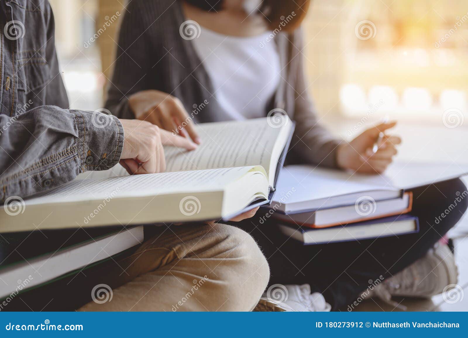 Two Students are Sitting on the Floor Reading Books To Education. Study ...