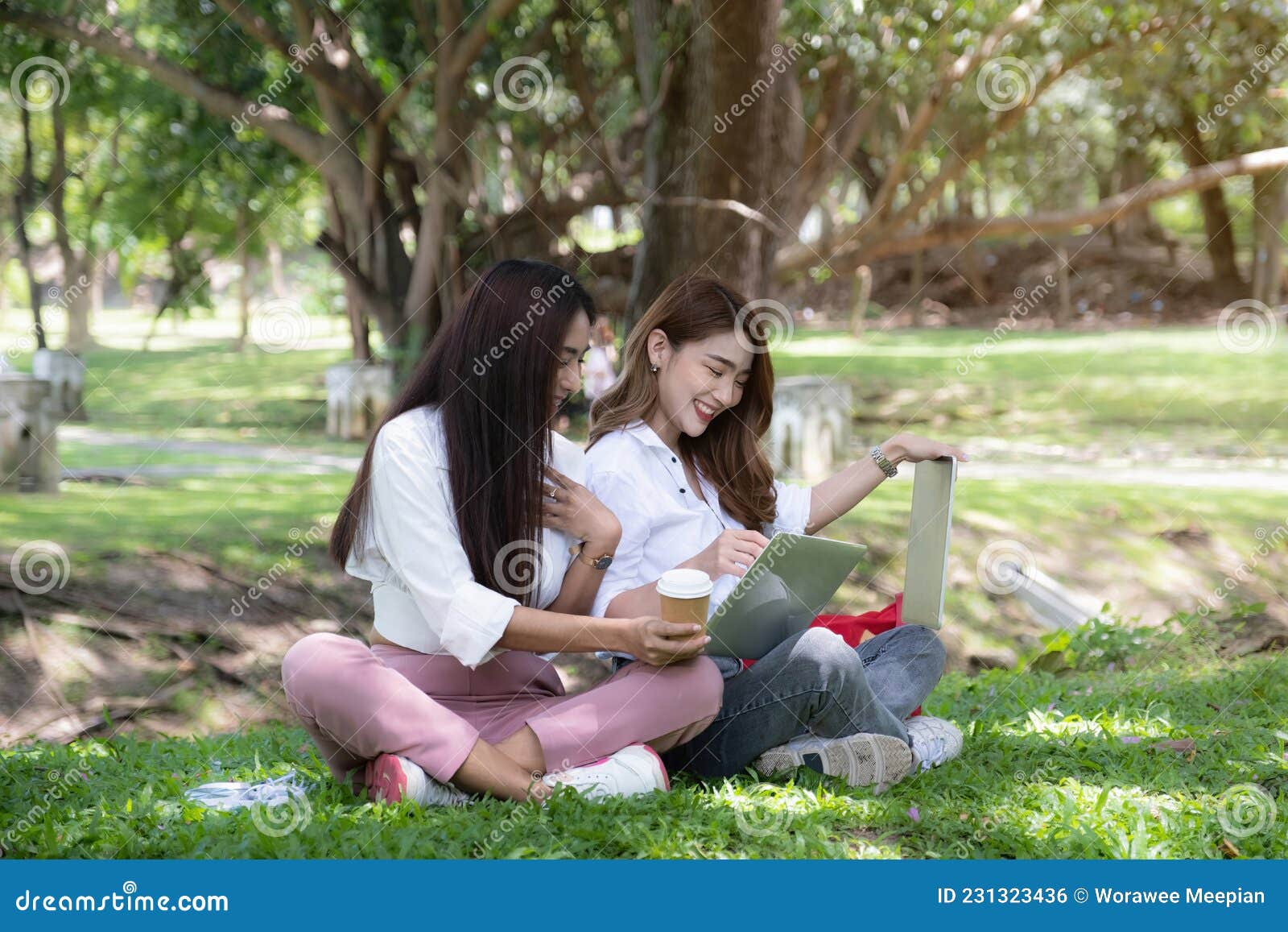 Two Students are Sitting in University during Reading a Book and ...