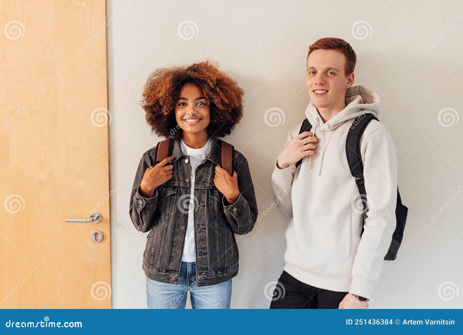 Two Students Standing Together at Wall and Looking at Camera Stock ...