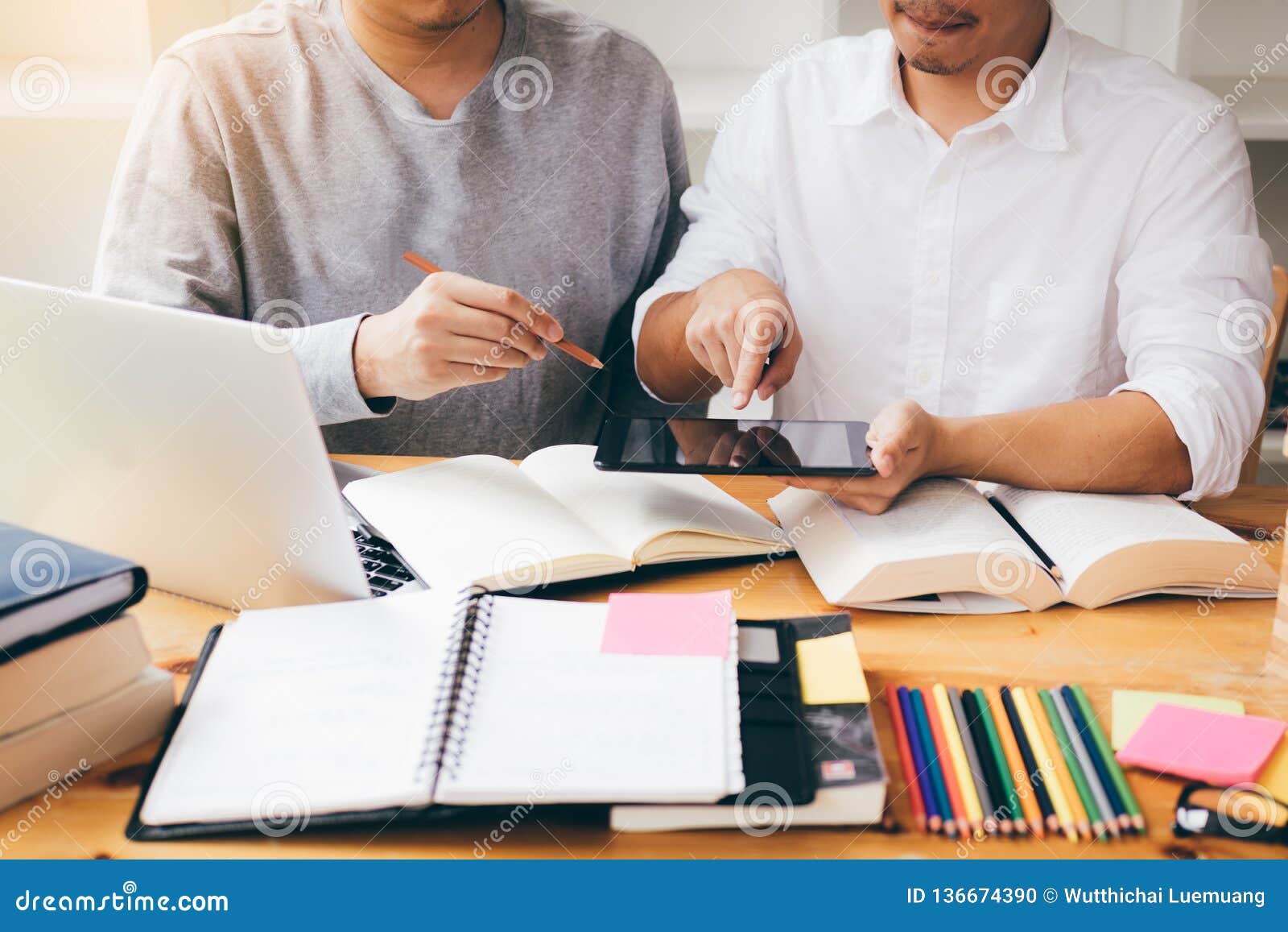 Two Students Studying and Learning in Library with a Laptop and Notes ...