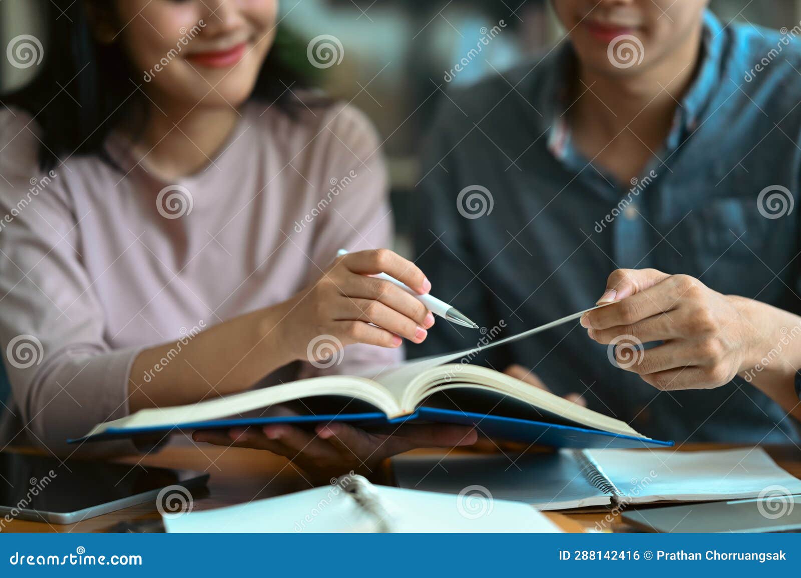 Two Students Studying, Reading Textbooks Together, Working on ...
