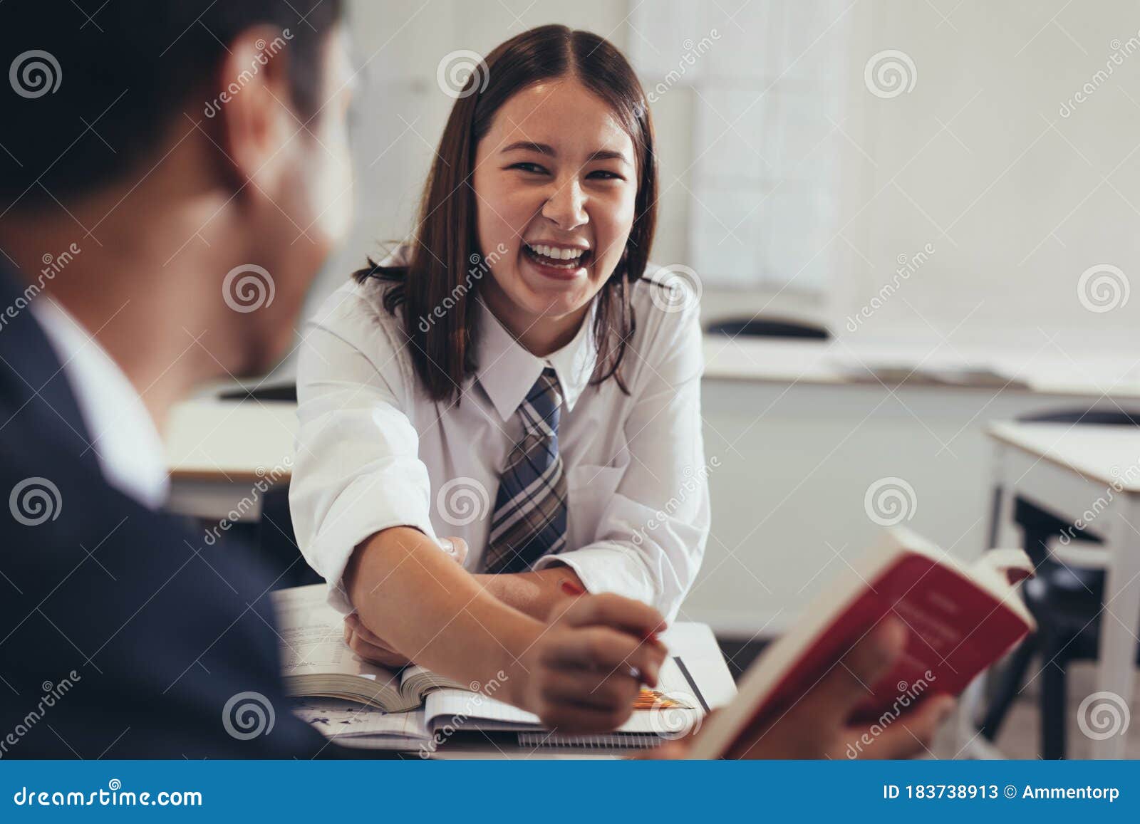 Two Students Talking and Smiling in Classroom Stock Image - Image of ...