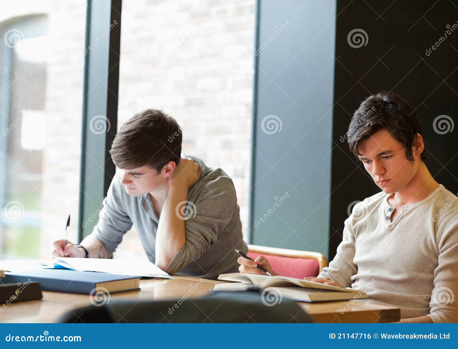 Two Students Working on an Assignment Stock Photo - Image of partners ...
