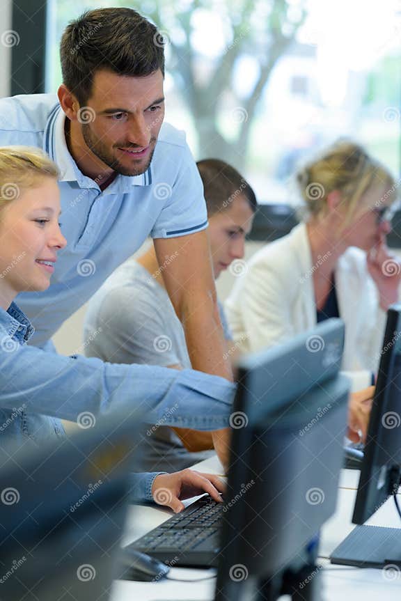Two Students Working on Computers in Classroom Stock Image - Image of desk, shirt: 323414293
