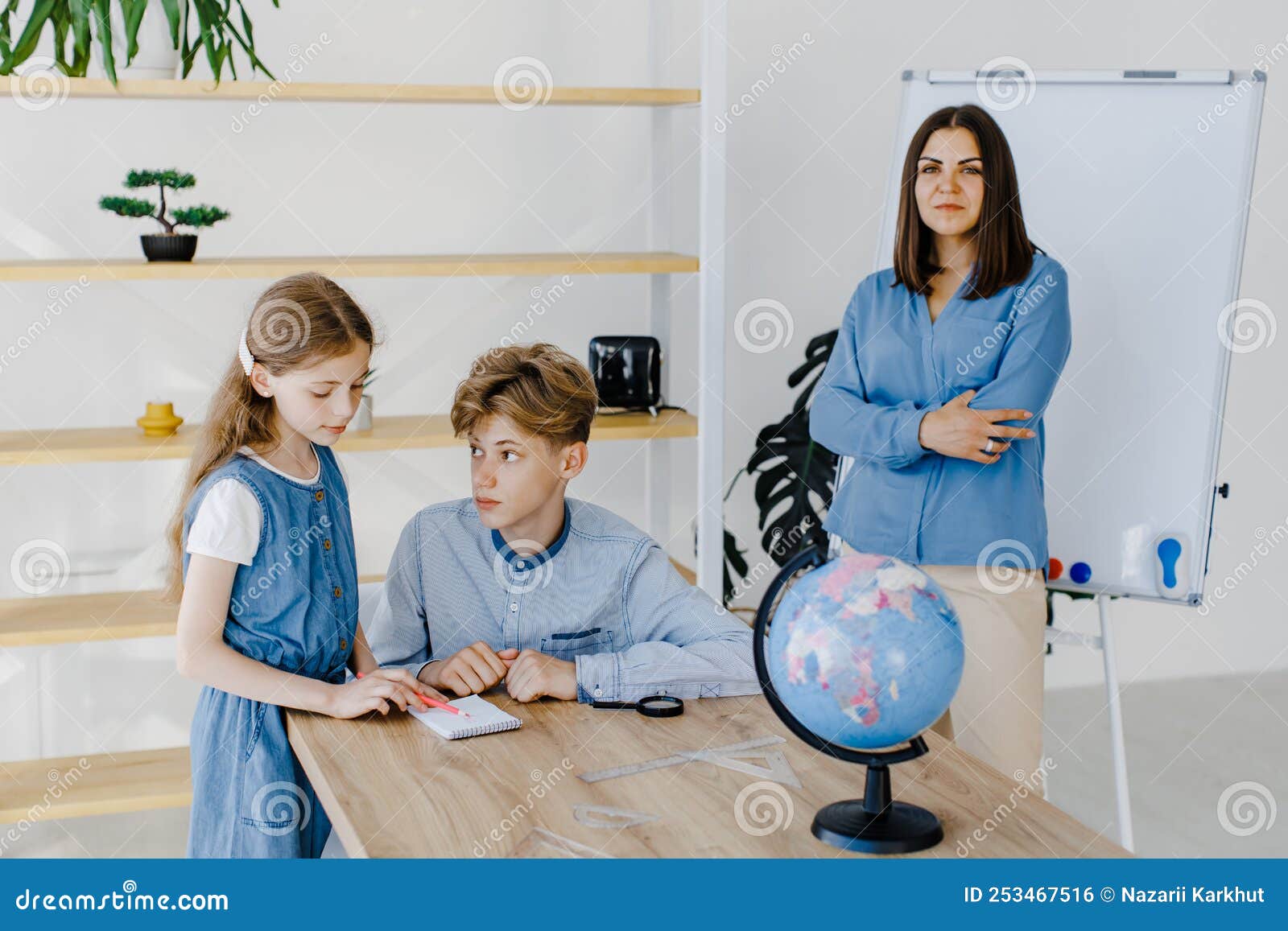 Two Students are Working on a Project at School in a Spacious Classroom ...