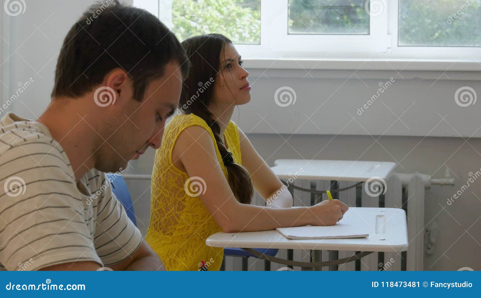 Two Students Writing Notes in the Classroom. Stock Image - Image of ...