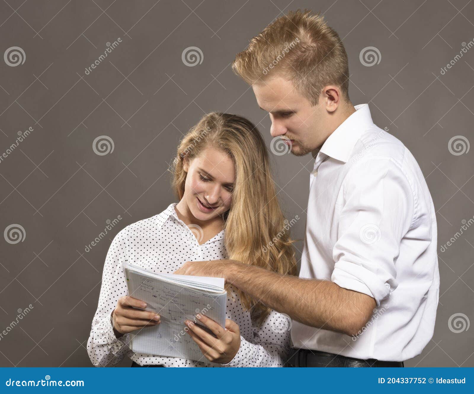 Two Students Young Man and Woman Watching Papers Stock Photo - Image of ...