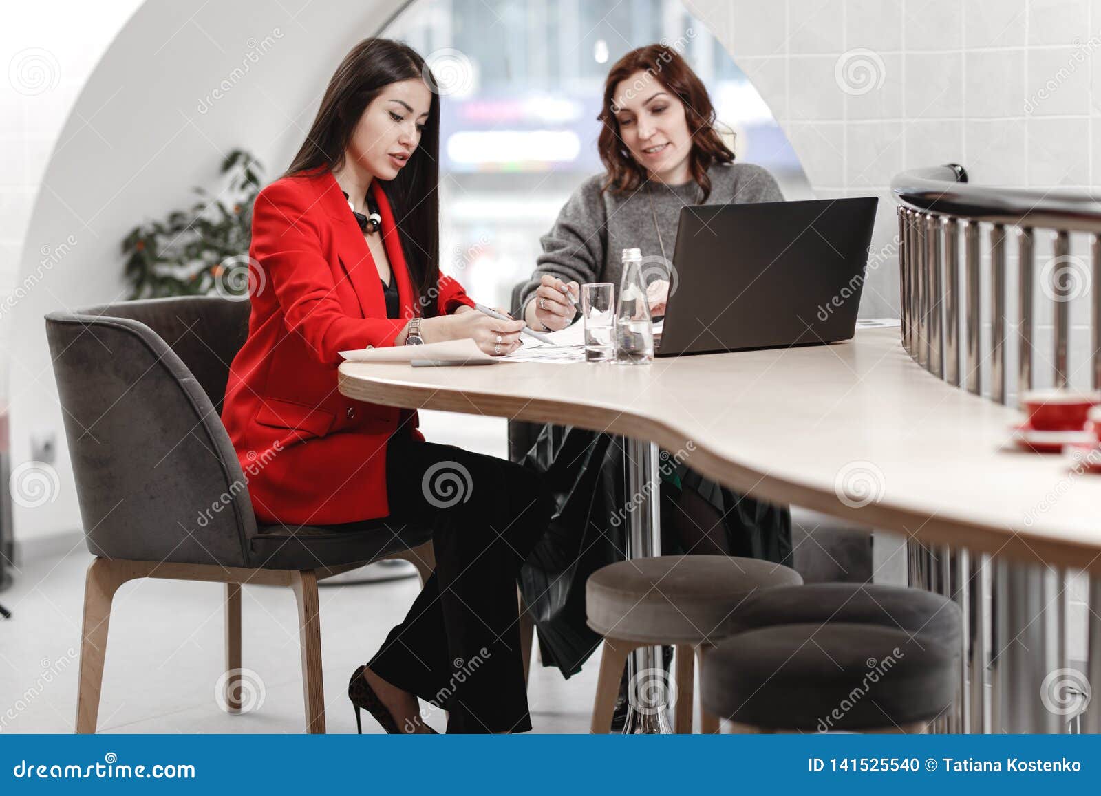 Two Stylish Girls Interior Designers Working in the Office at the ...