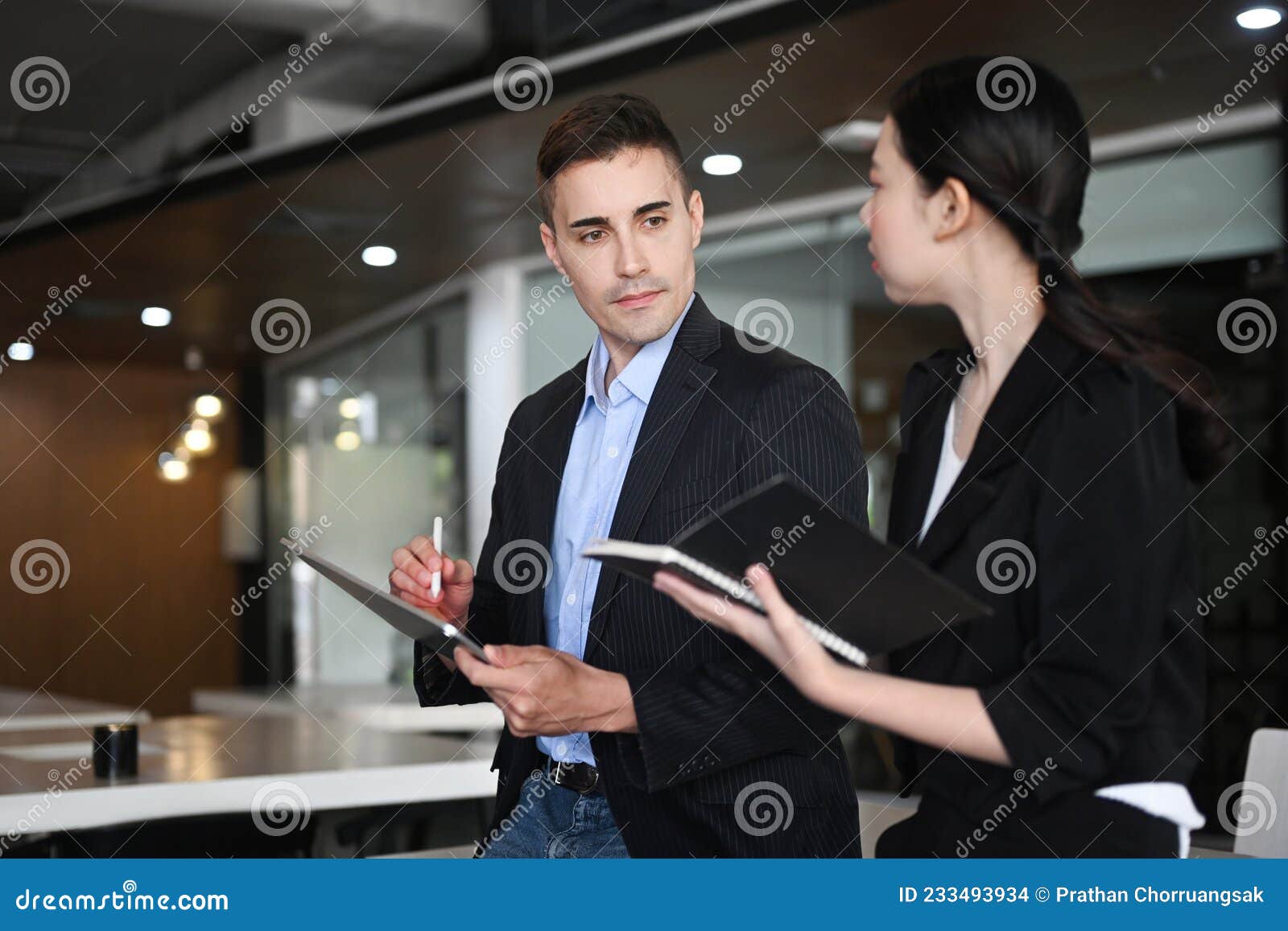 Two Business People Sharing Ideas and Working on Project Together ...