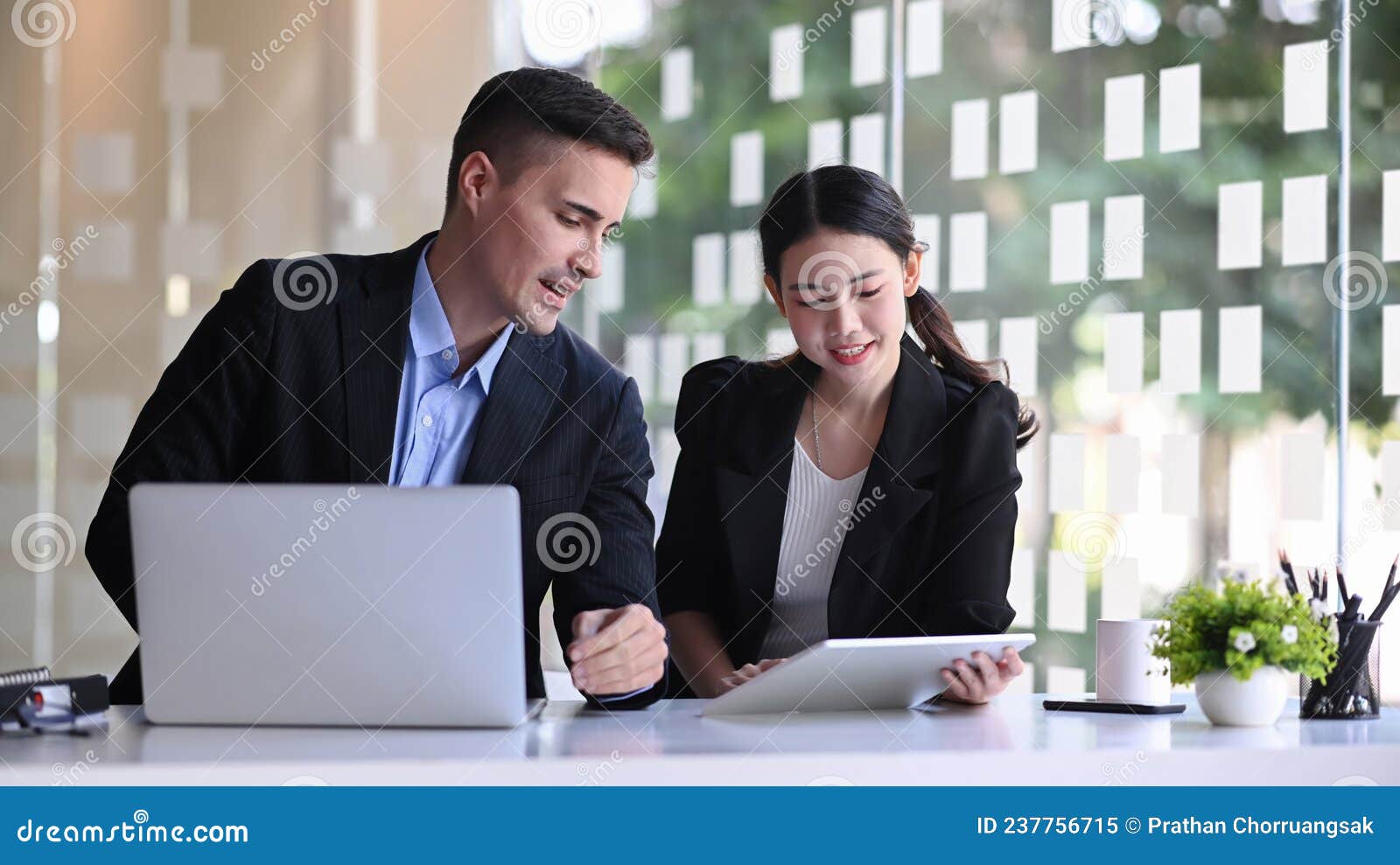 Two Businesspeople Working Together in Modern Workplace. Stock Image ...