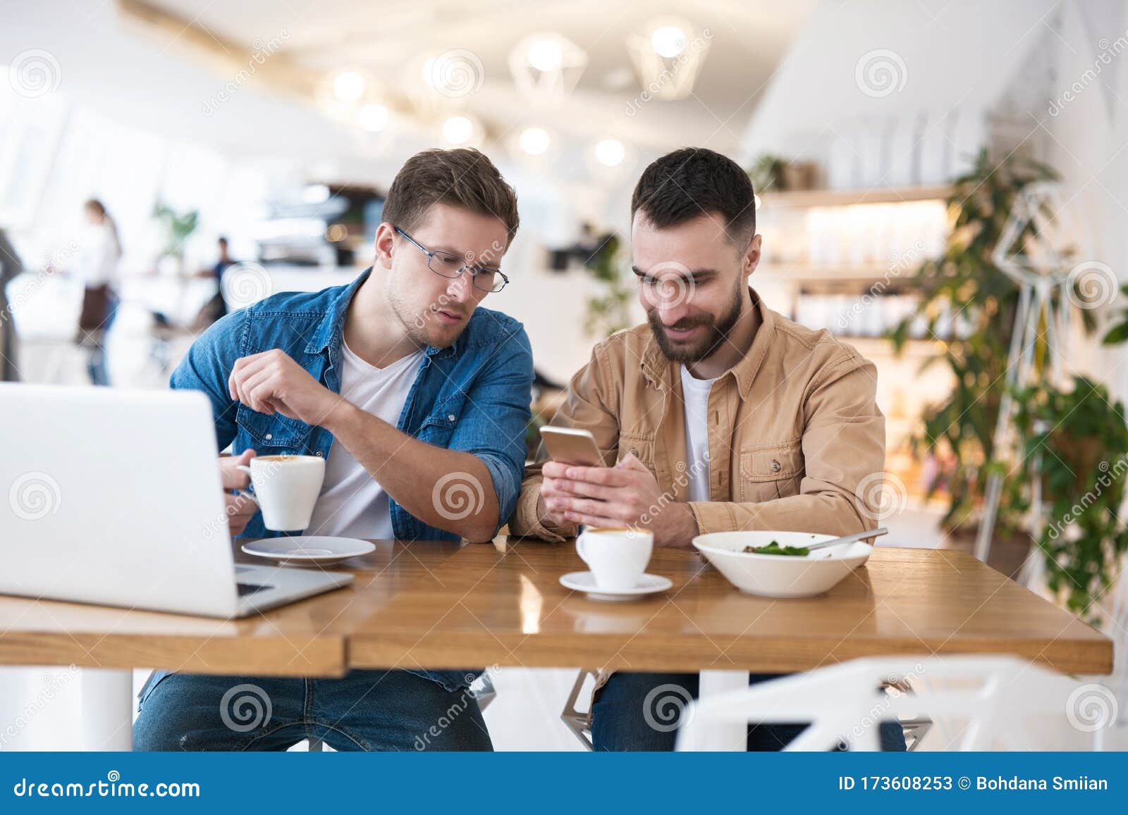 Two Successful Smiling Colleagues Men Solving Work Issues during Coffee ...