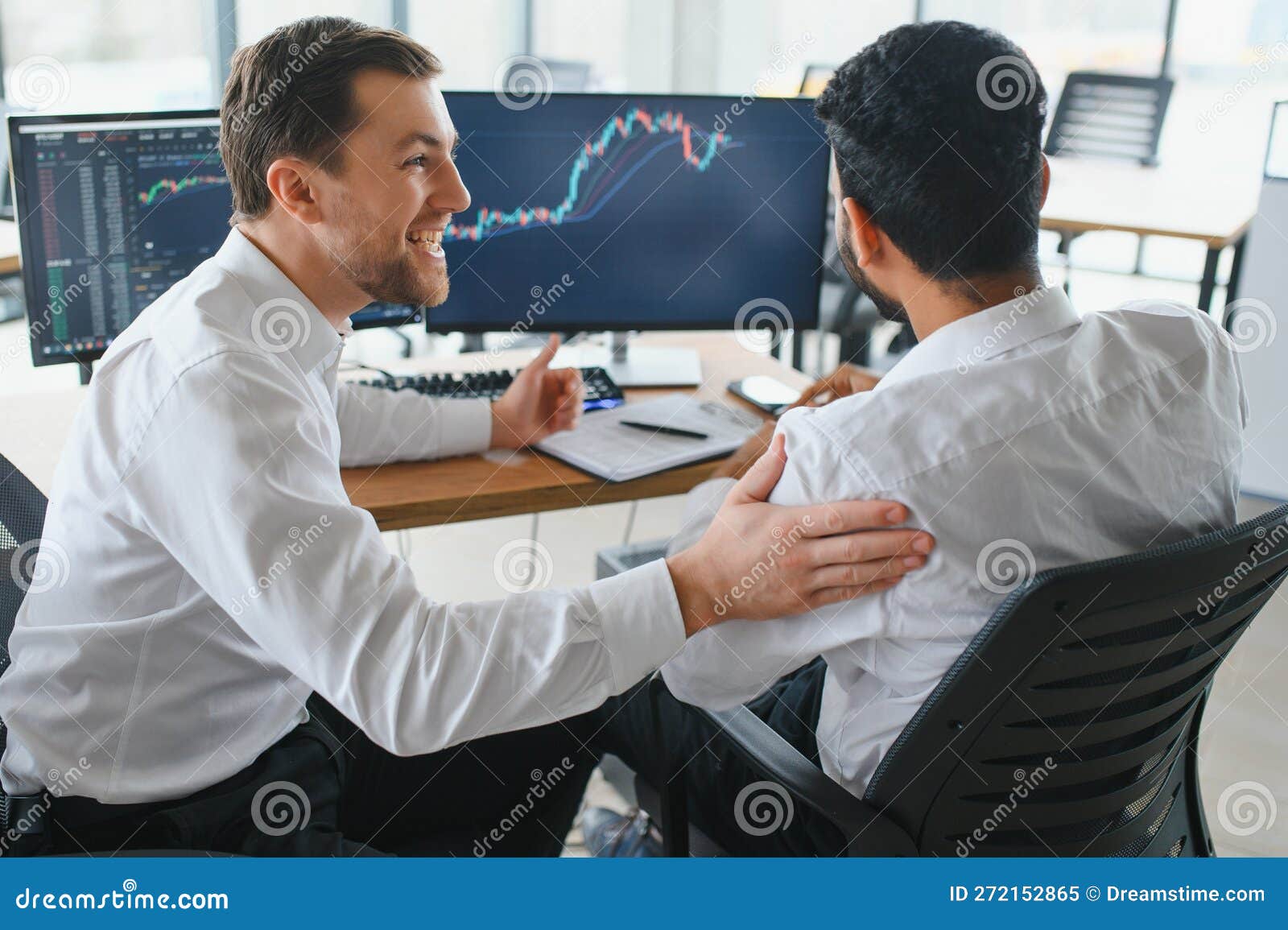 Two Successful Trader Sitting in Office and Looking at Screen, Checking ...