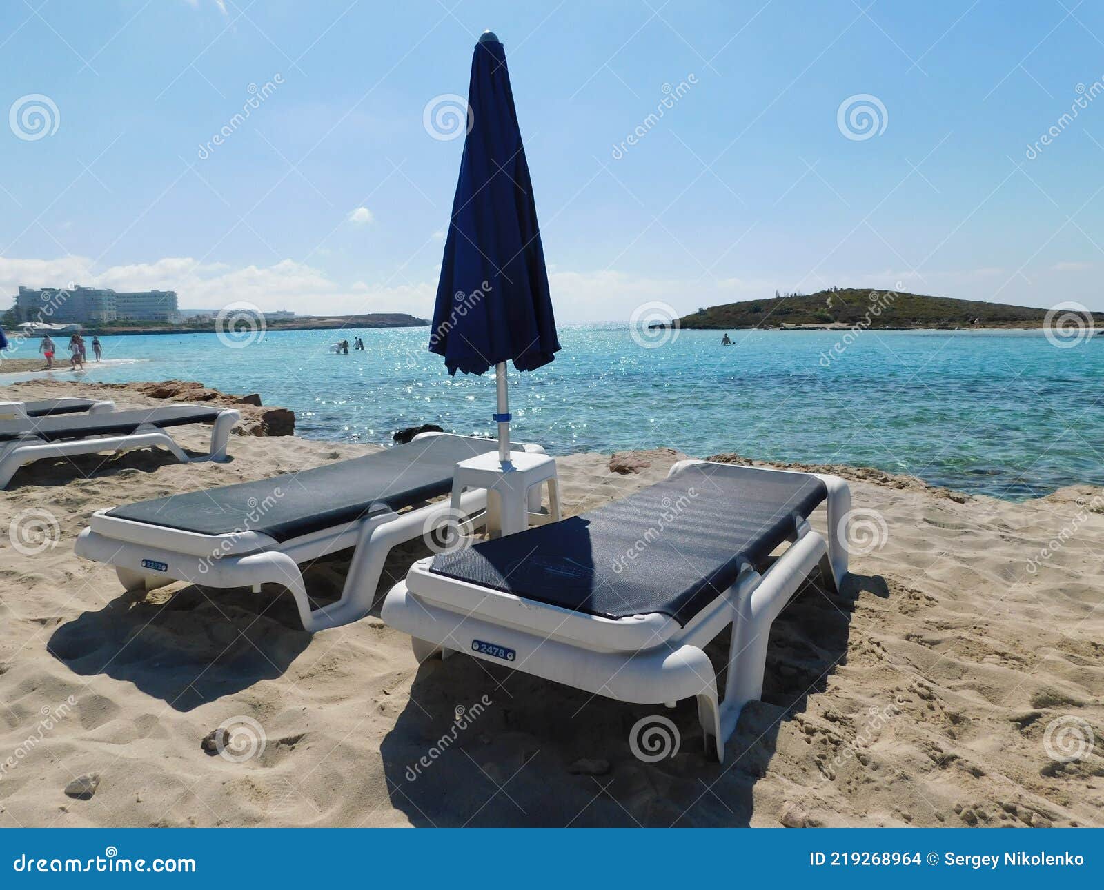 Two Sun Beds and an Umbrella on the Fig Tree Beach. Protaras Stock ...