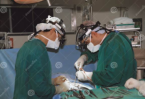 Two surgeons operating stock image. Image of physician - 1143507