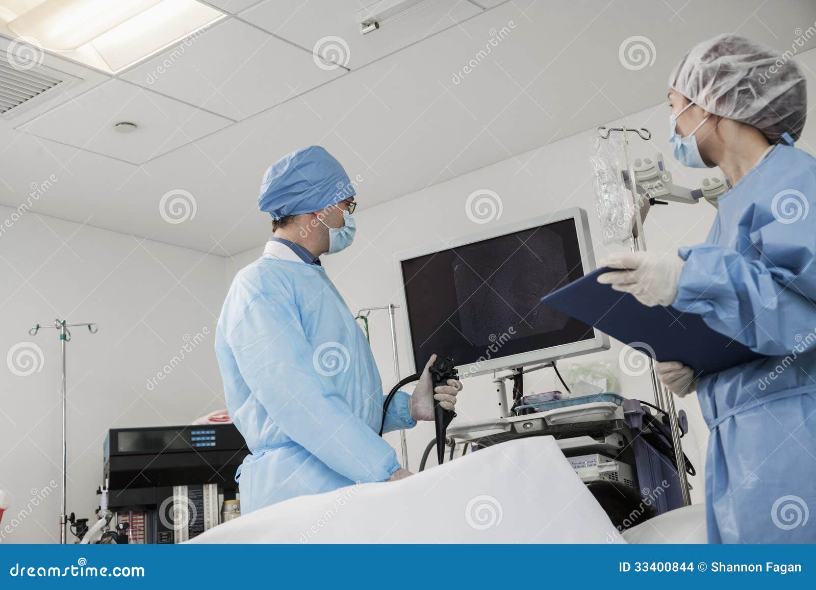 Two Surgeons Preparing for Surgery, Patient Lying Down Stock Photo ...