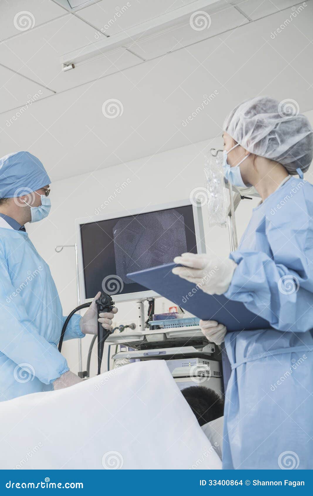 Two Surgeons Preparing for Surgery, Patient Lying Down Stock Photo ...