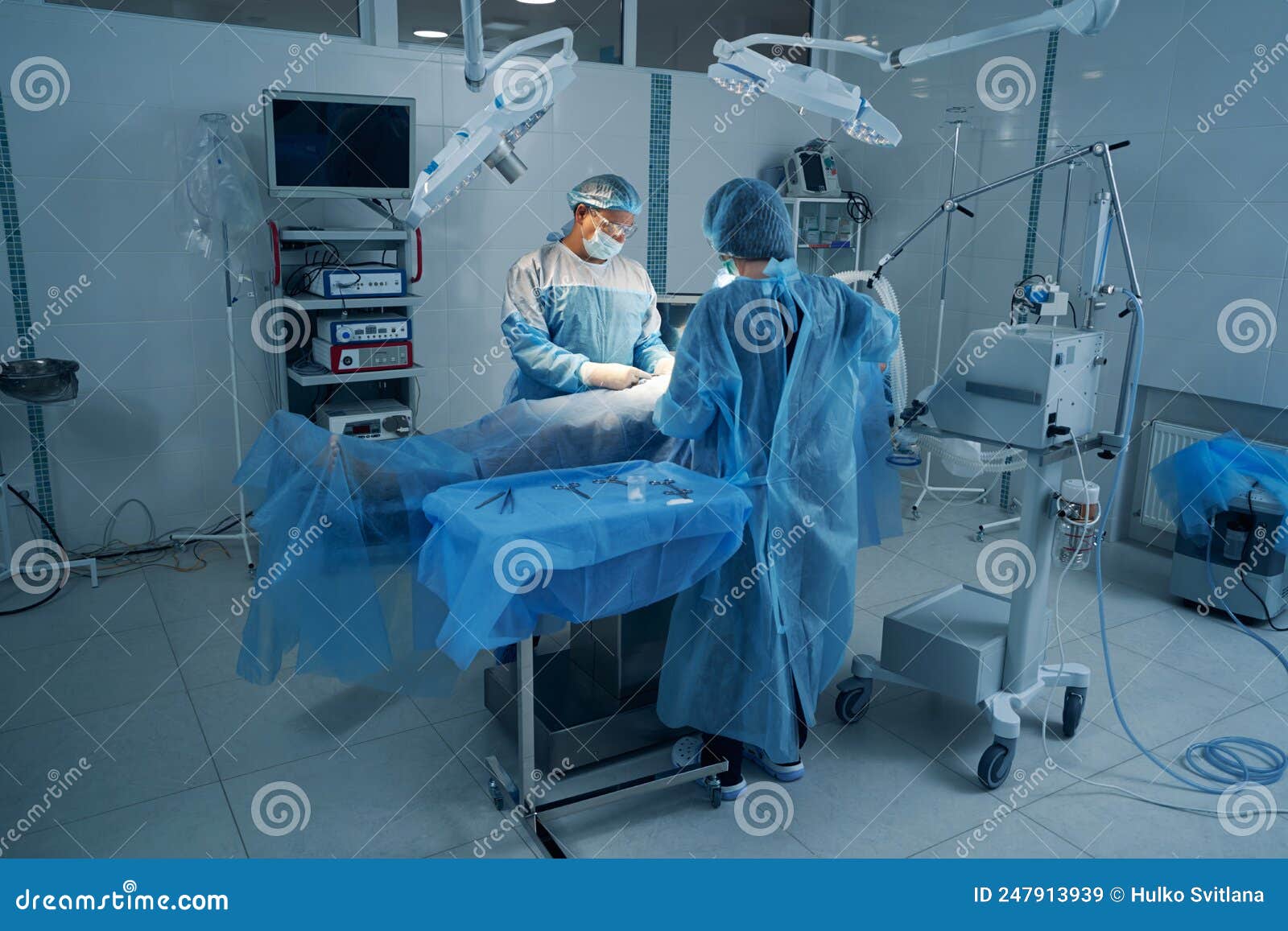 Two Surgery Experts Conducting Laparoscopic Operation on Patient Stock ...