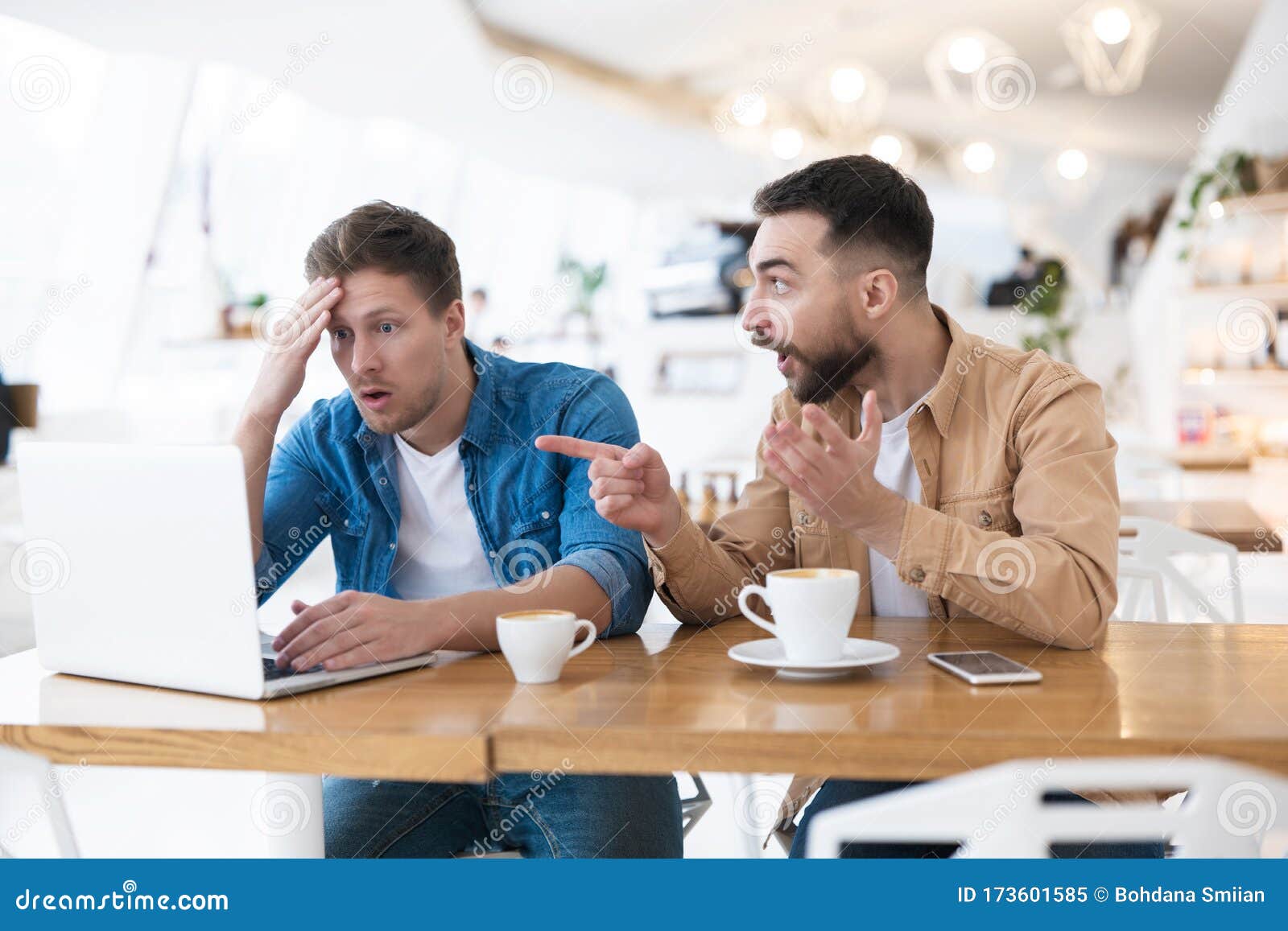 Two Surprised Colleagues Men Solving Work Issues during Lunch Break at ...