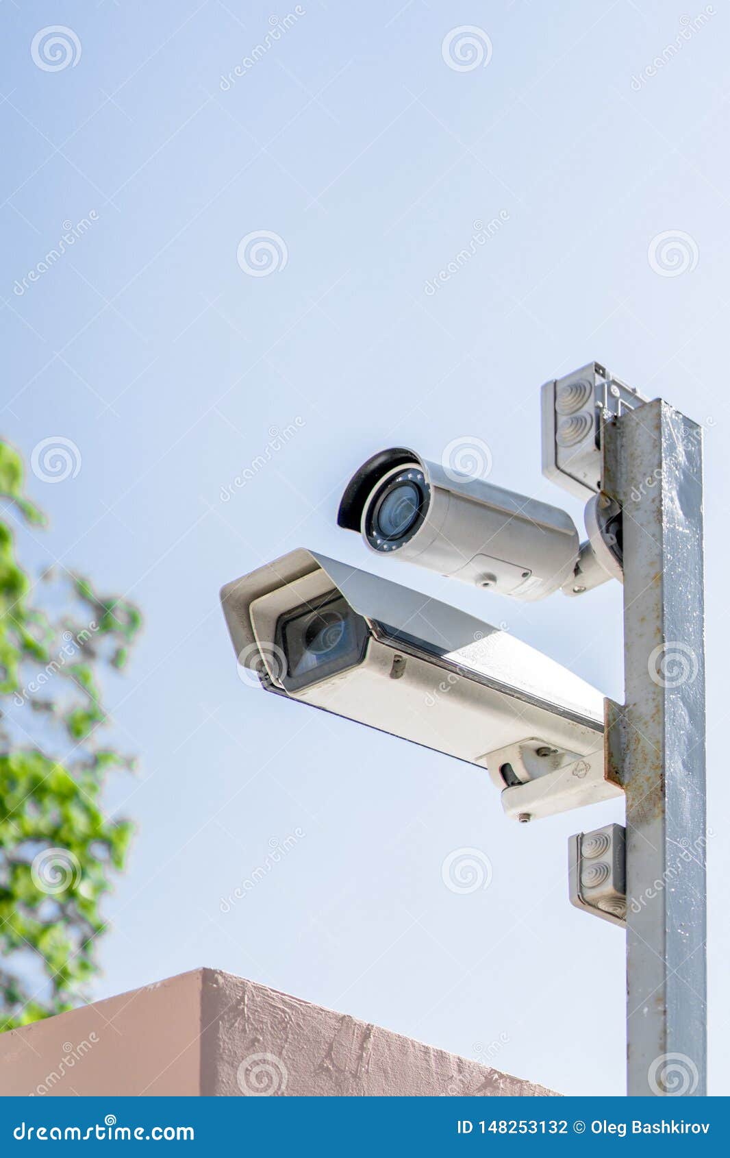 Two Surveillance Cameras on a Pole Against a Blue Sky Stock Photo ...