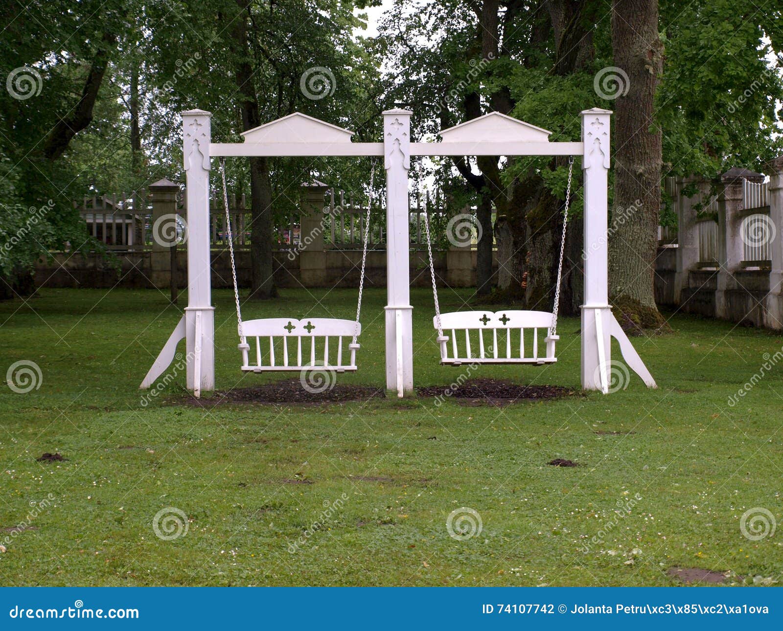 Two swings in the garden stock photo. Image of rainy - 74107742