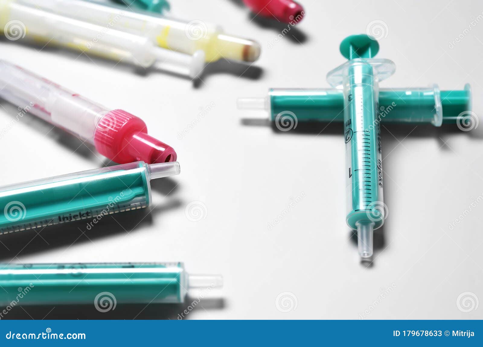 Two Syringes Forming Cross Surrounded with Syringes without Needles ...