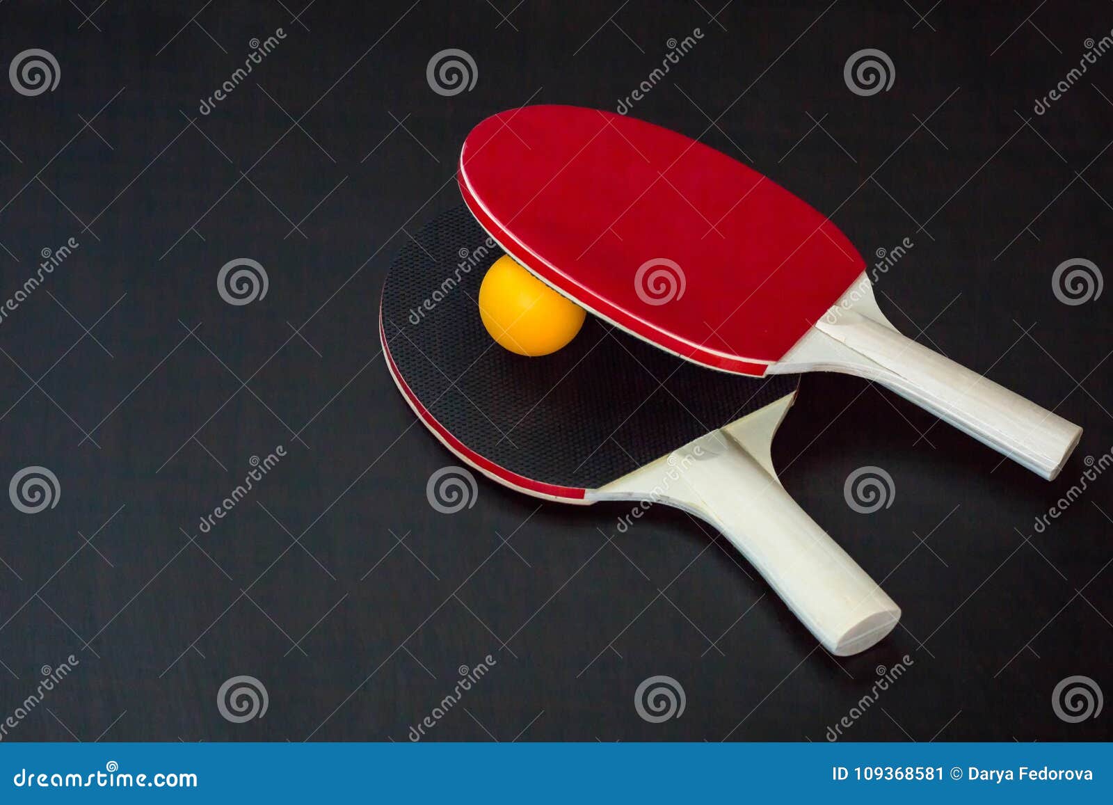 Two Table Tennis or Ping Pong Rackets and Ball on a Black Background ...