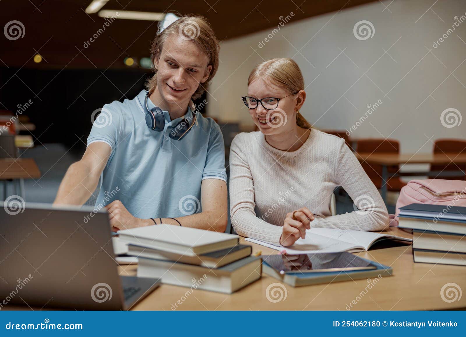 Two Talented Students Working Together on University Project Sitting in ...