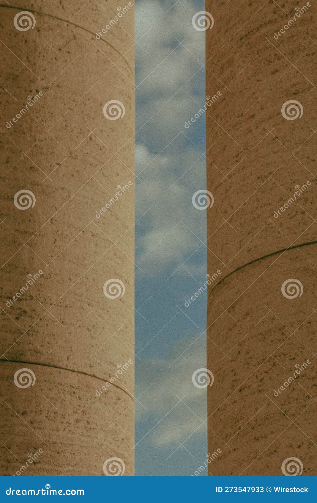 Two Tall Pillars Standing Side by Side in Front of a Blue Sky with ...