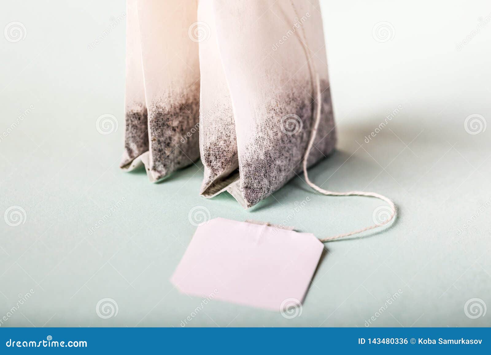 Two Tea Bags with White Label on Light Background Stock Photo - Image ...