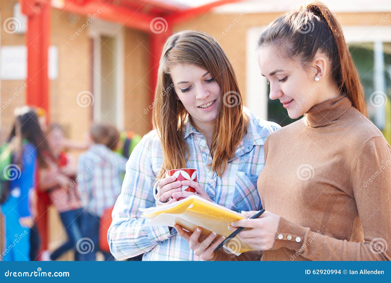 Two Teachers in Playground with Register at Break Time Stock Photo ...