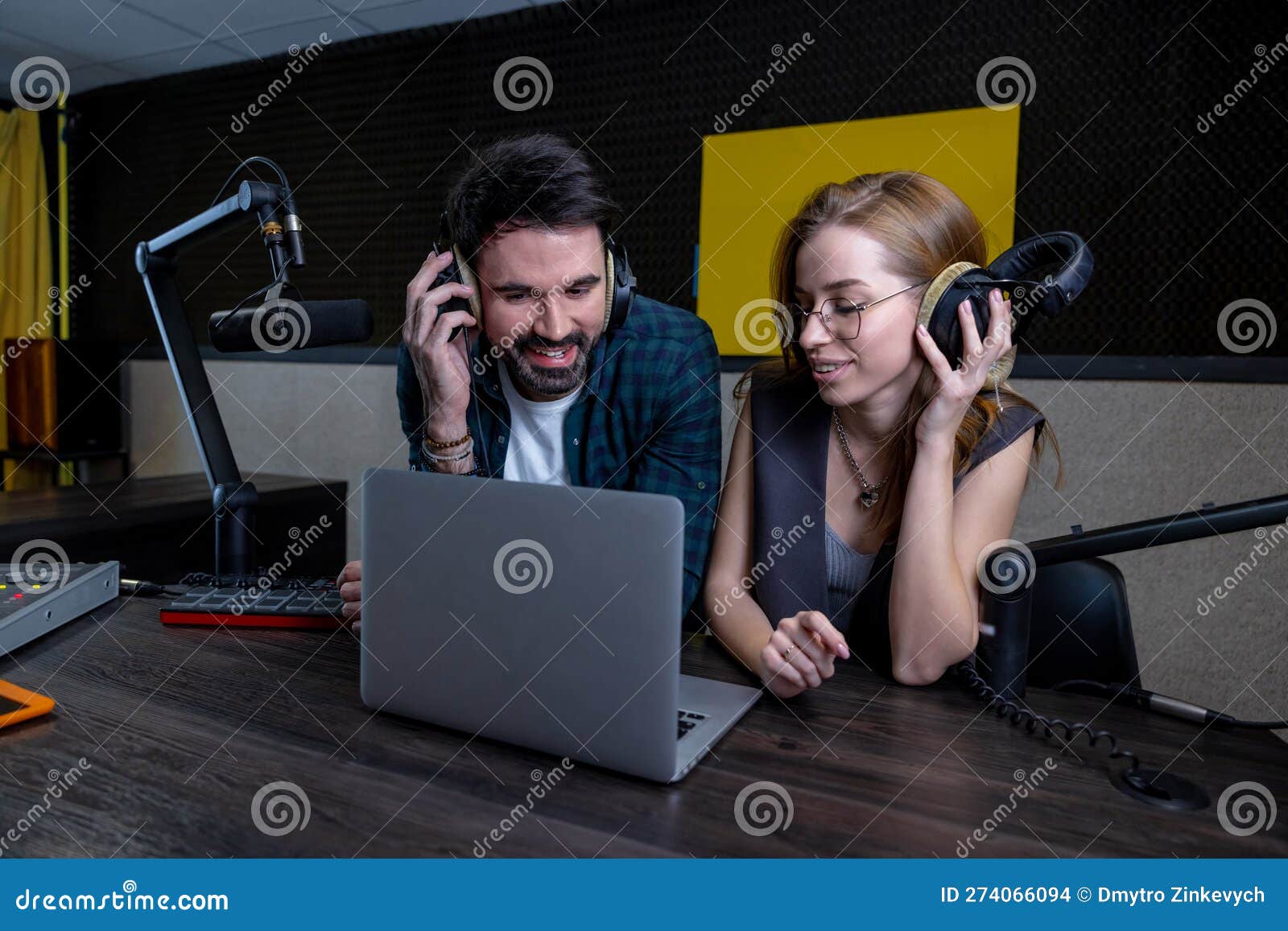 Two Team Members Having a Sound Check and Looking Involved Stock Photo ...