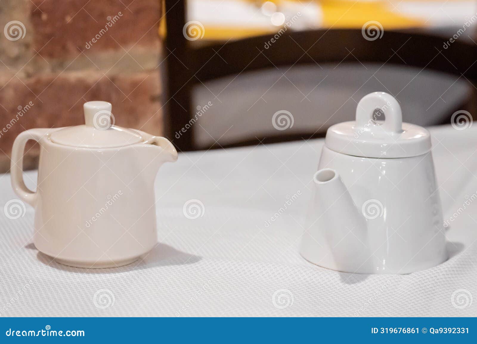 Two Teapots on Table with Brick Wall Background Stock Image - Image of ...