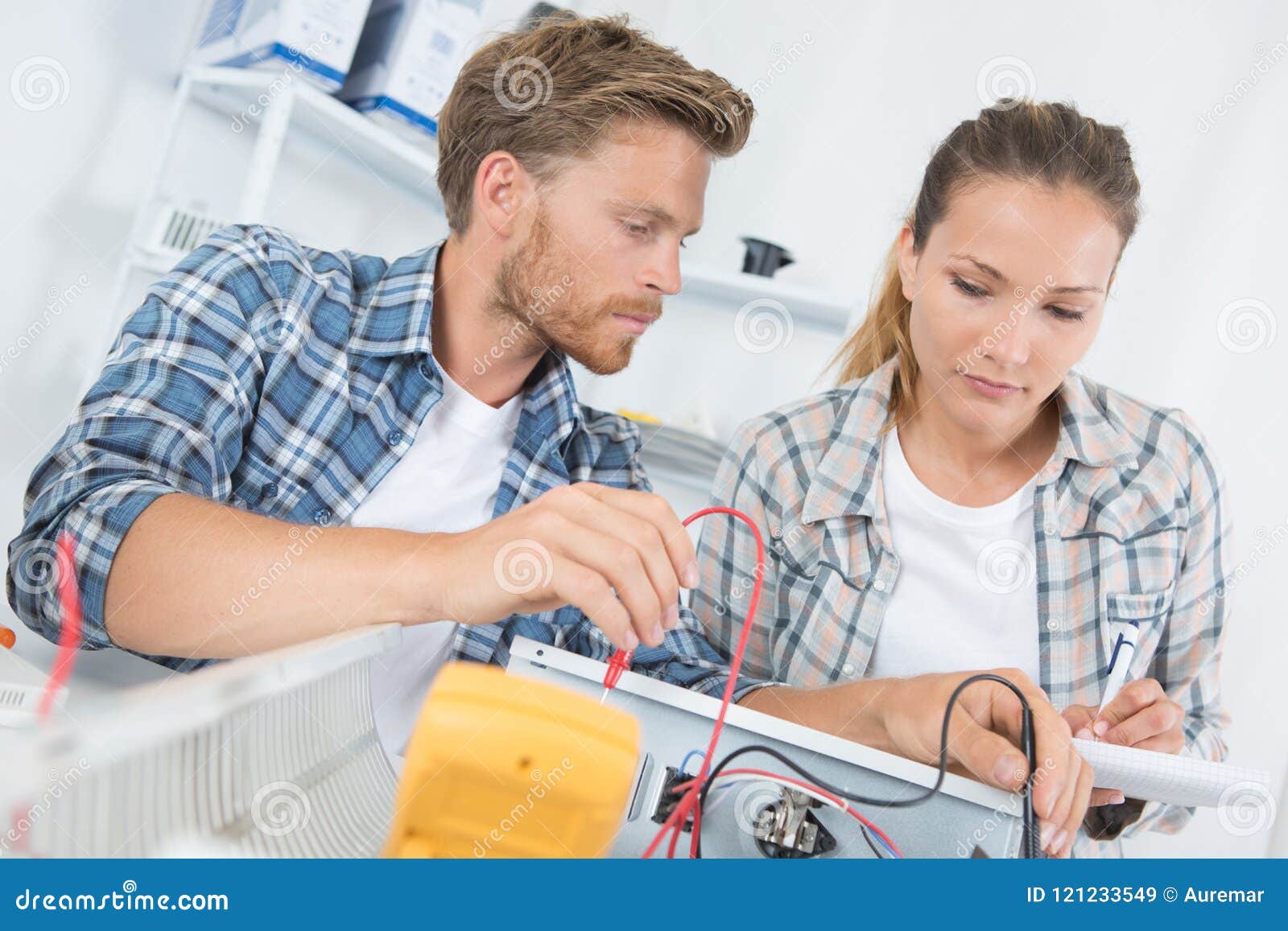 Two Technicians Testing Appliance with Multimeter Stock Image - Image ...
