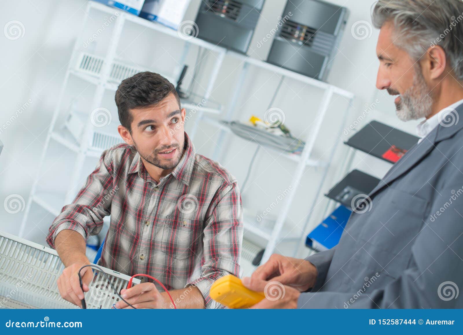 Two Technicians Using Multimeter on Electrical Appliance Stock Photo ...