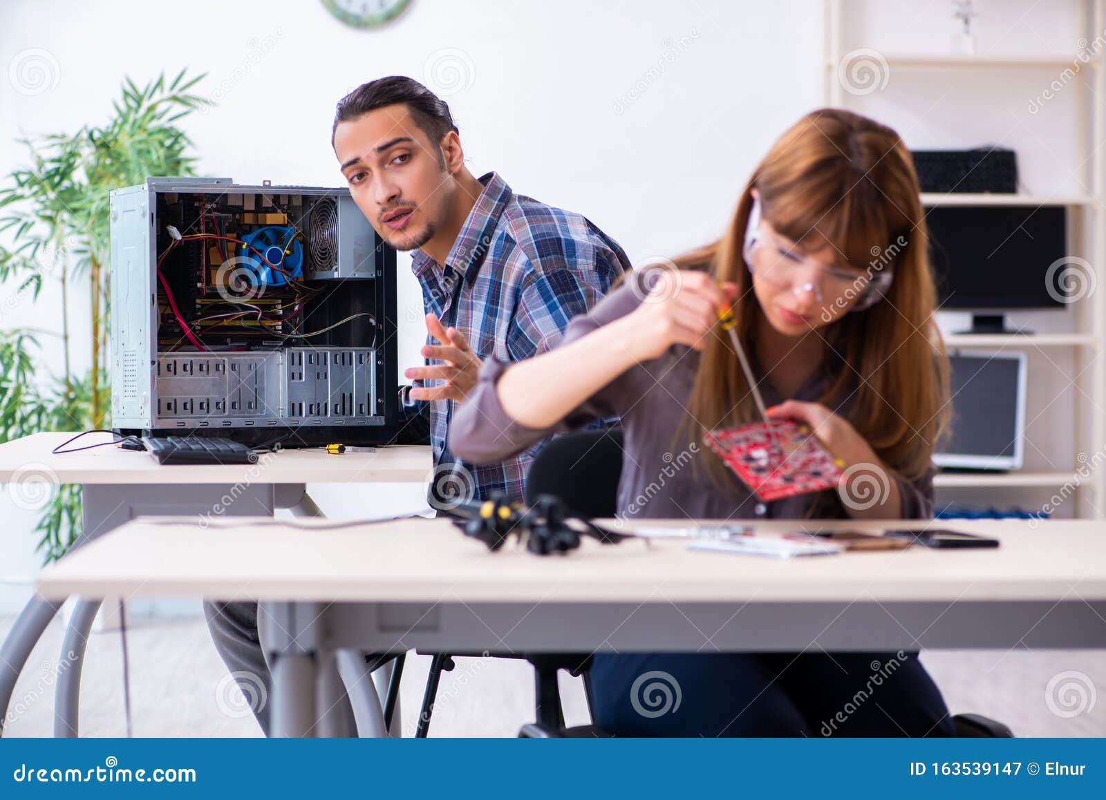Two Technicians Working at Computer Warranty Center Stock Image - Image ... Two Technicians Working at Computer Warranty Center Stock Image - Image ...