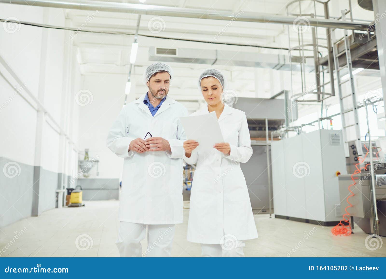 Two Technologists in Lab Coats and Masks at the Factory. Stock Photo ...