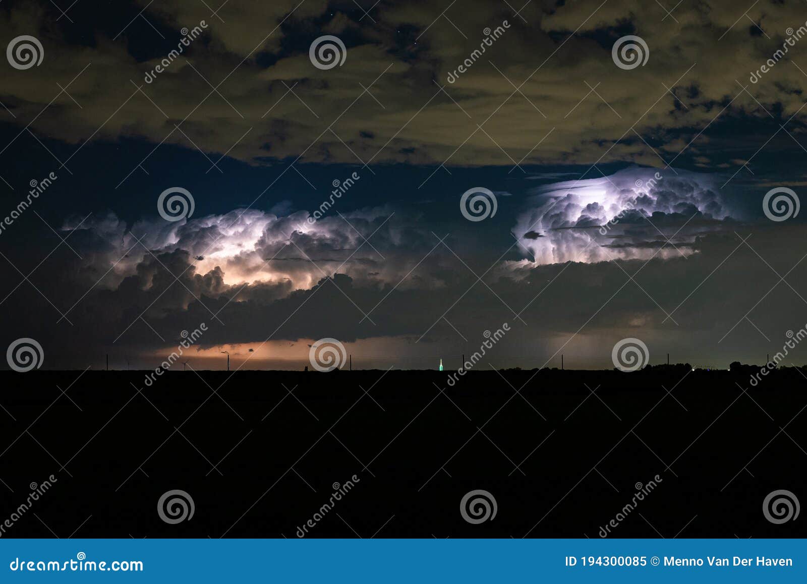 Two Thunderstorms Illuminated by Lightning Stock Image - Image of ...