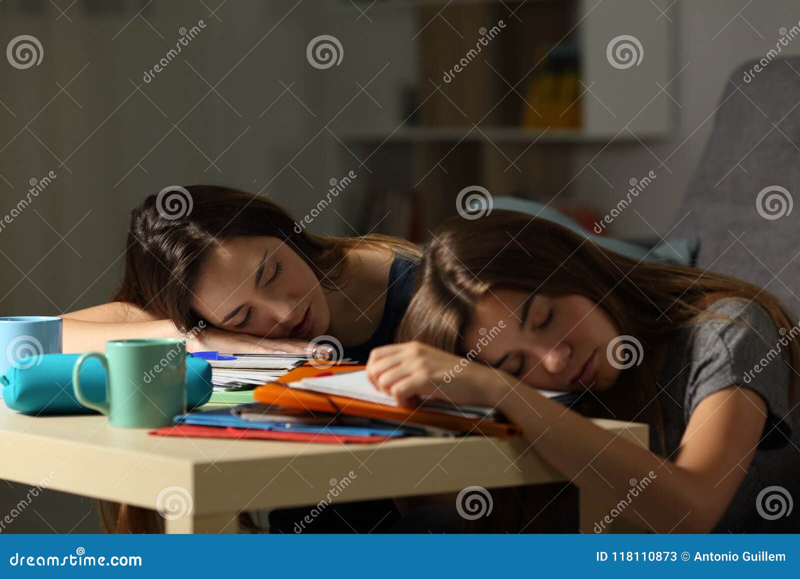Two Tired Students Sleeping Over Notebooks in the Night Stock Image ...