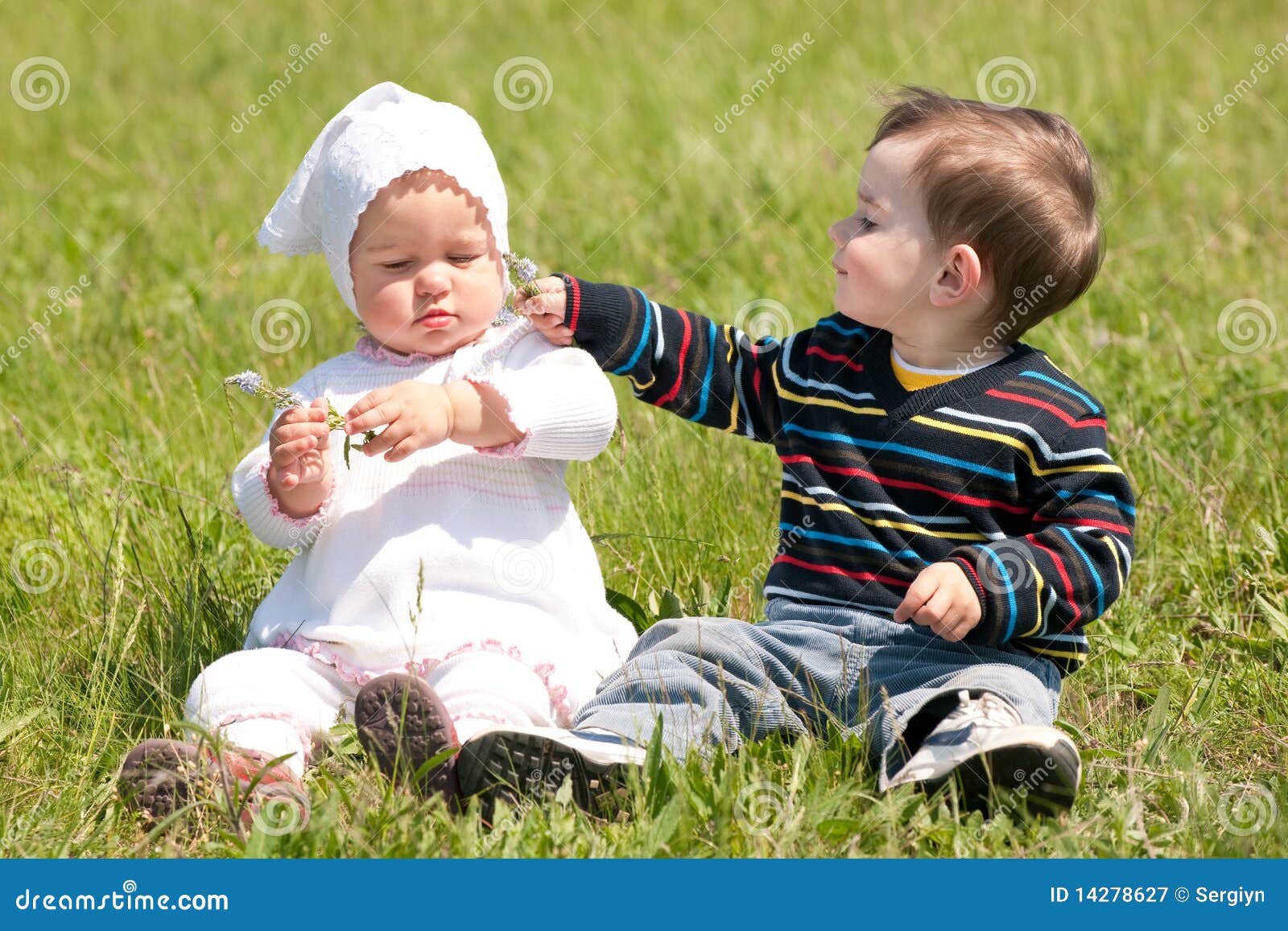 Two toddlers on the grass stock image. Image of love - 14278627