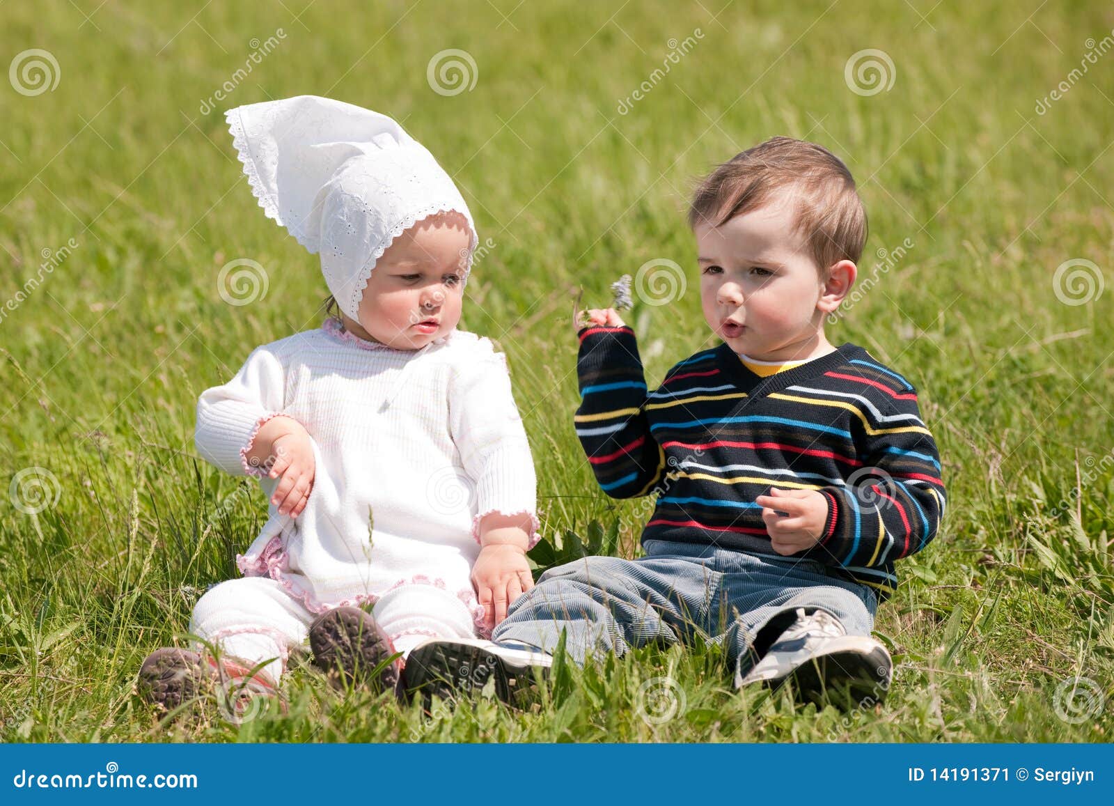 Two Toddlers on the Green Grass Stock Image - Image of cuddle, child ...
