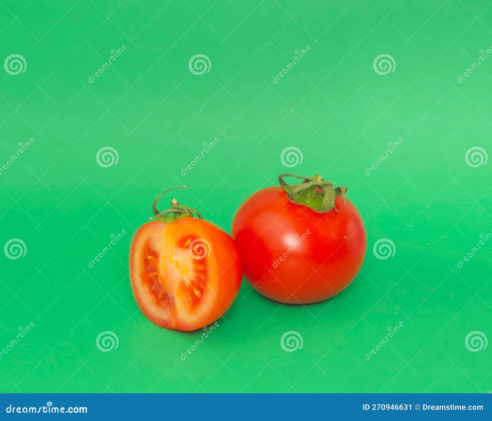 Two Tomatoes on Top of a Green Surface Next To Each Other Stock Image ...