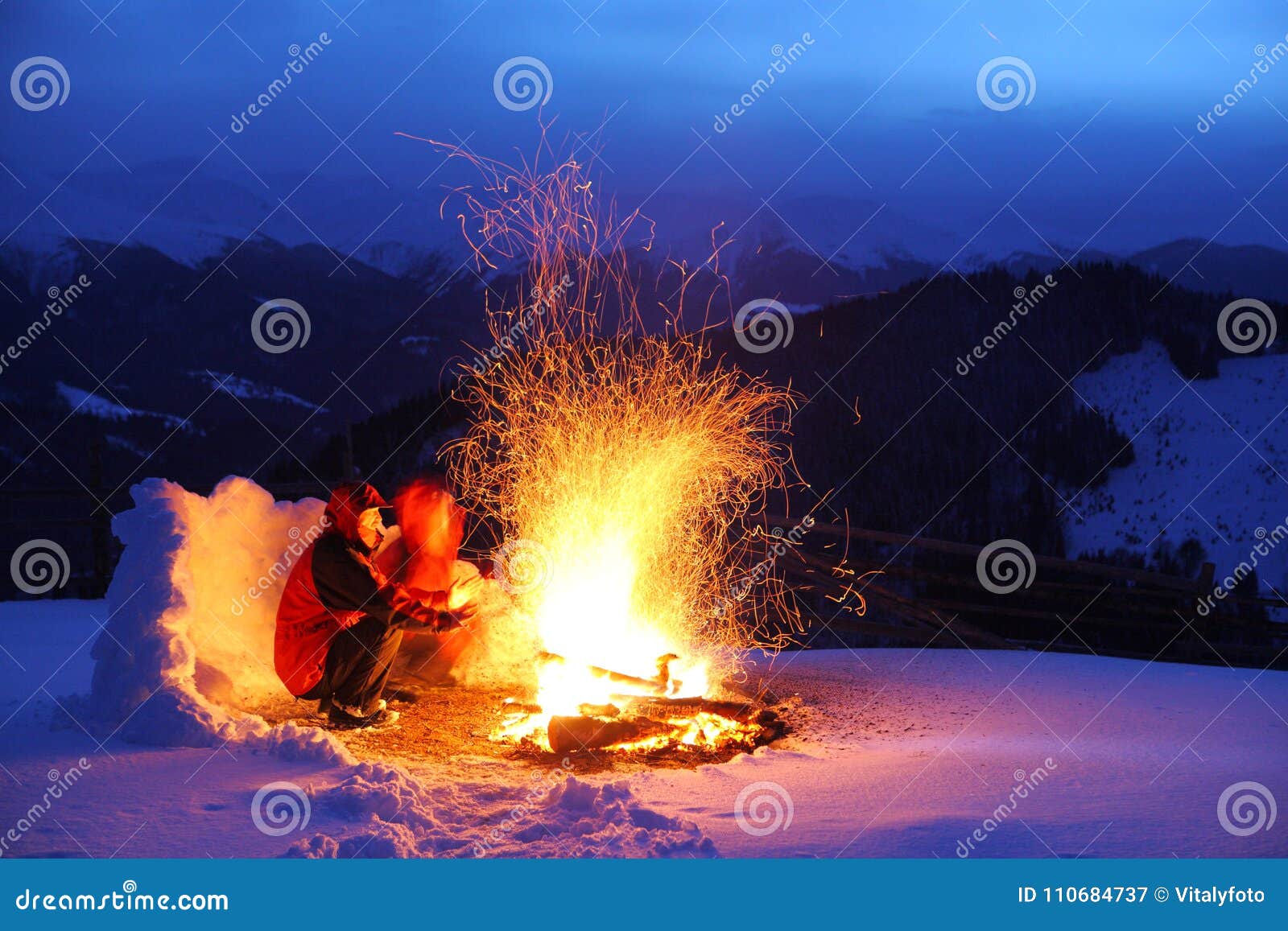 Two Tourists are Warming Up at the Fire Stock Image - Image of blue ...
