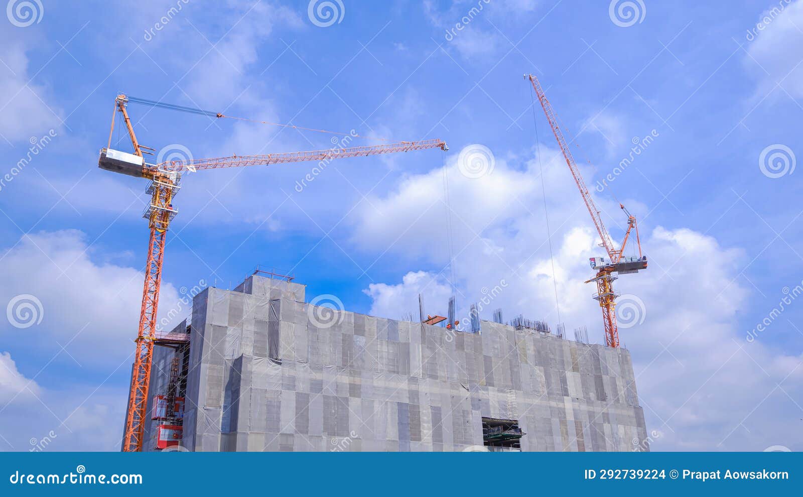 Two Tower Cranes are Working on Top of High Building Structure in ...