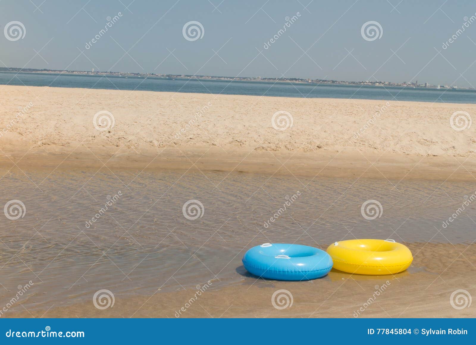 Two Toy Life Preservers Lying on the Beach Stock Photo - Image of ...