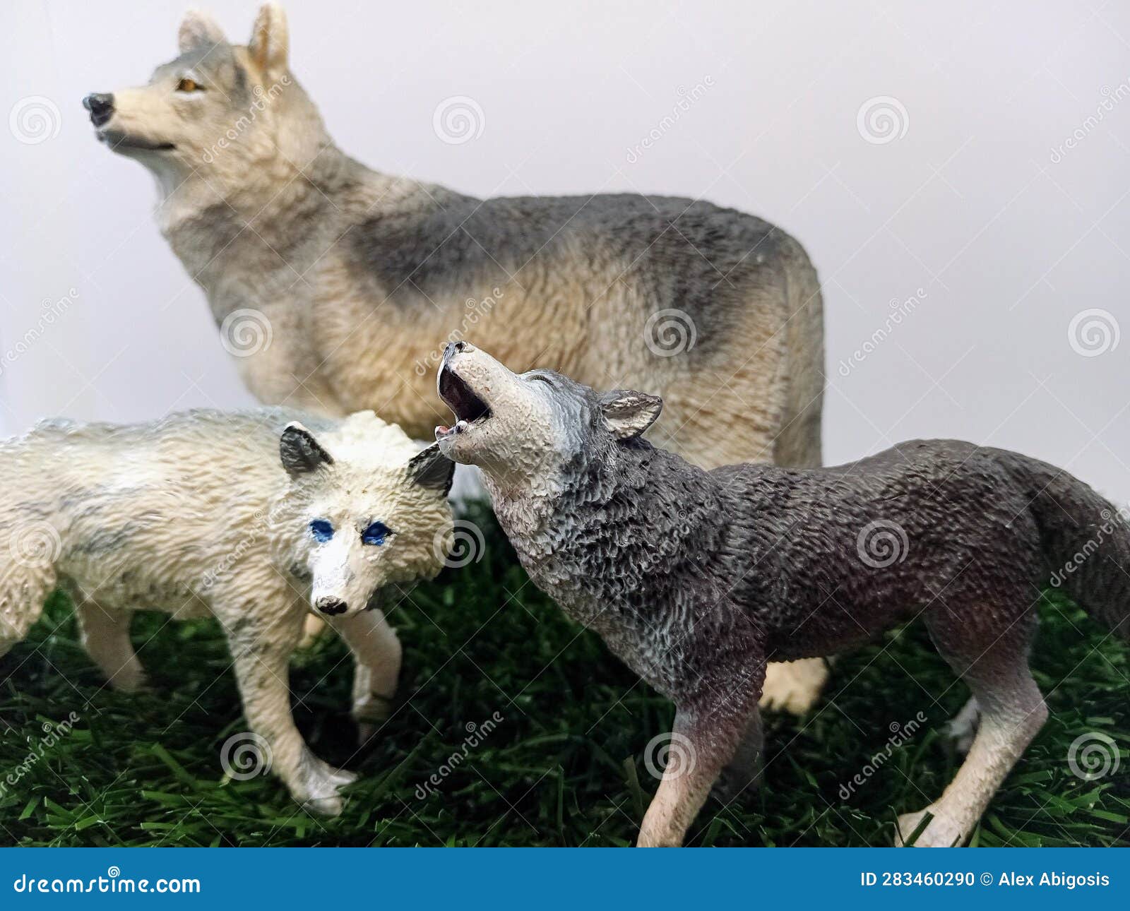 Three Toy Wolf Figures on Green Grass Stock Photo - Image of abstract ...