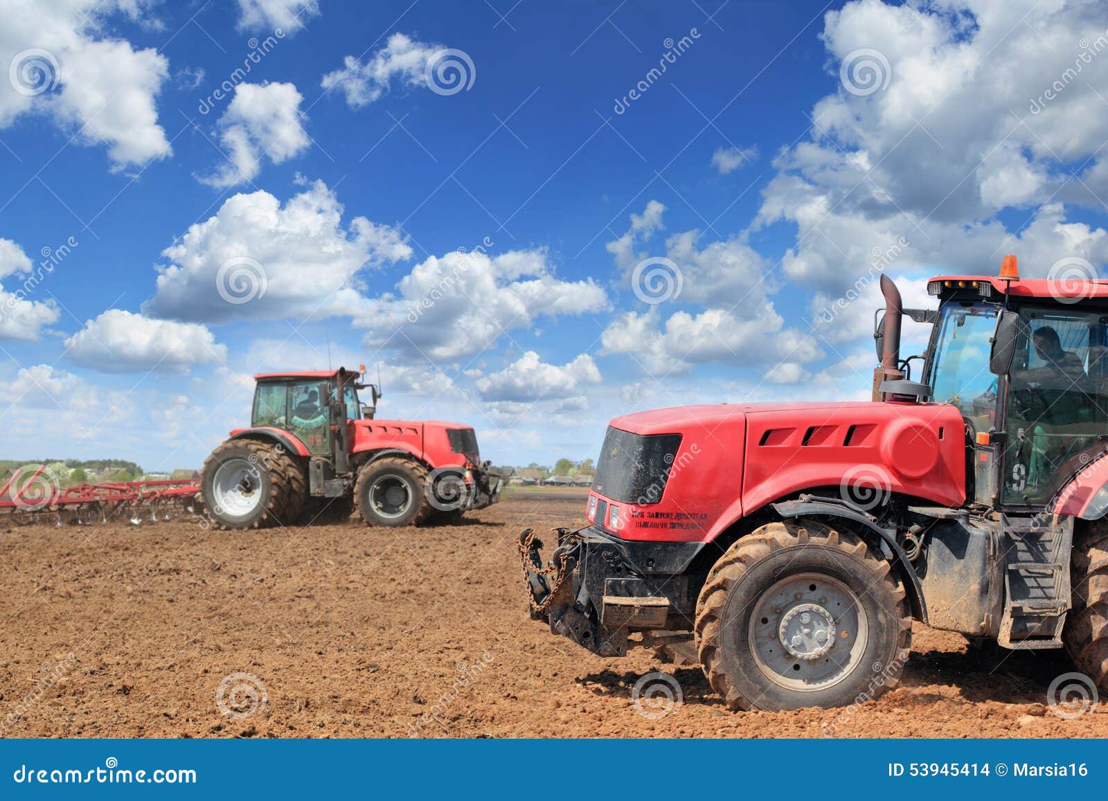 Two tractors on the field editorial stock image. Image of clouds - 53945414