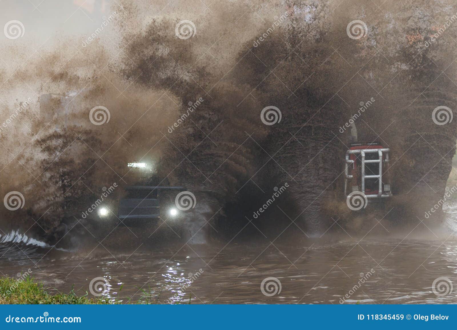 Two Tractors at High Speed Pass a Large Deep Puddle, Creating a Huge ...